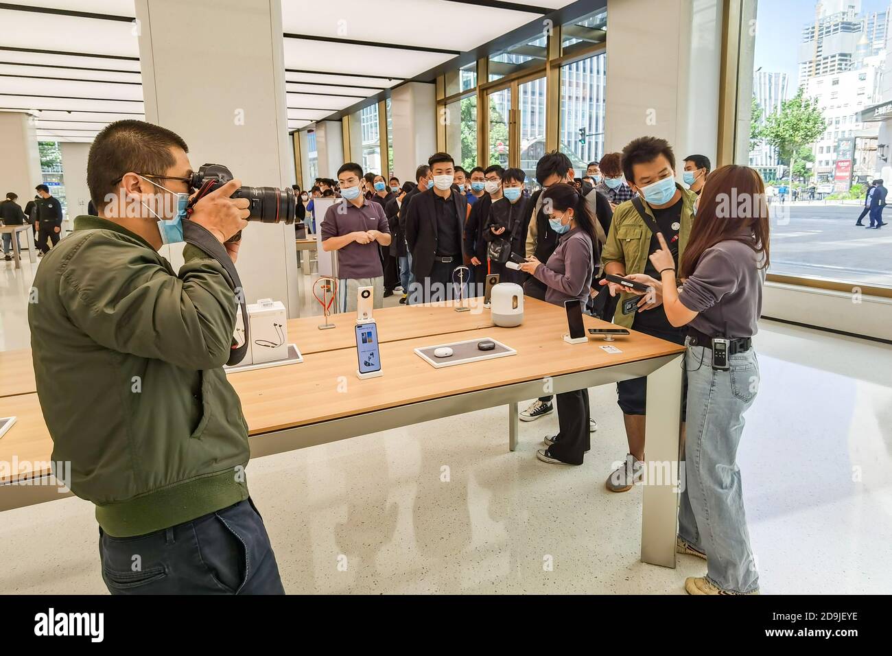 Customers queue at the flagship store of Huawei located on the east ...