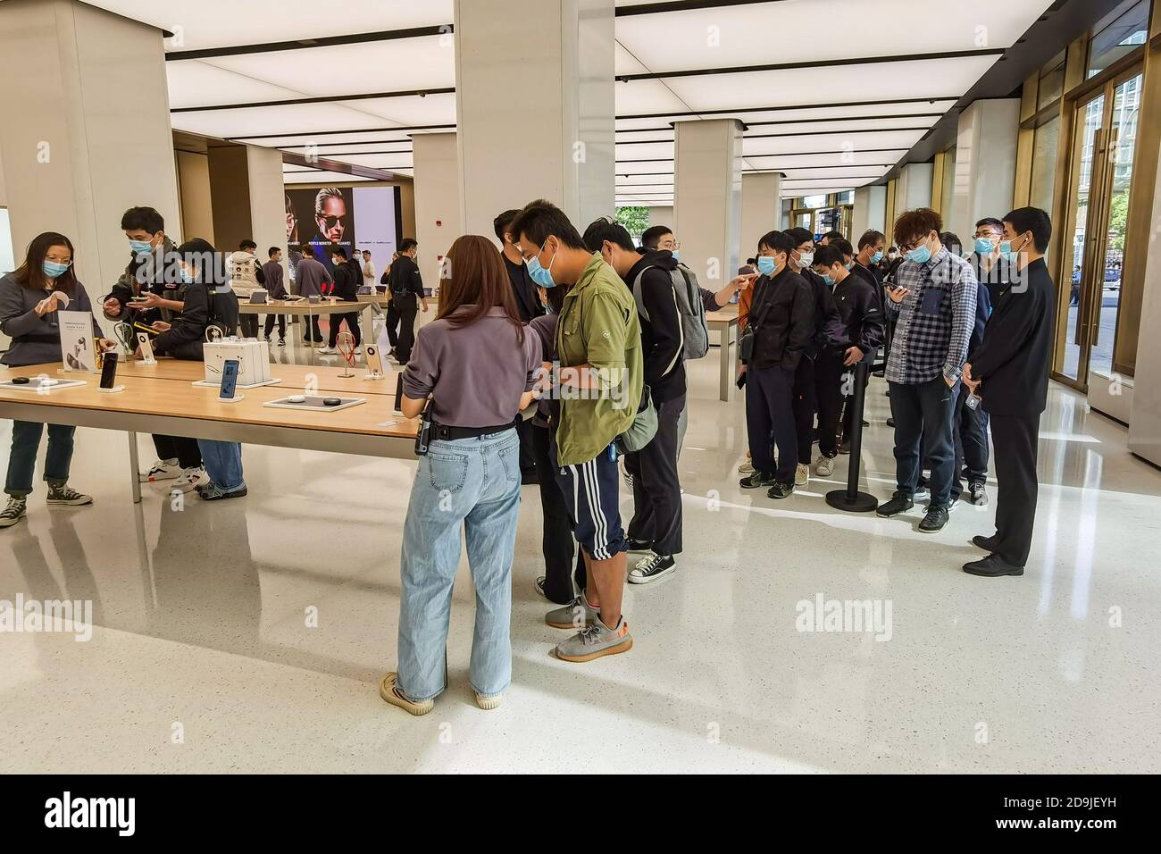 Customers queue at the flagship store of Huawei located on the east ...