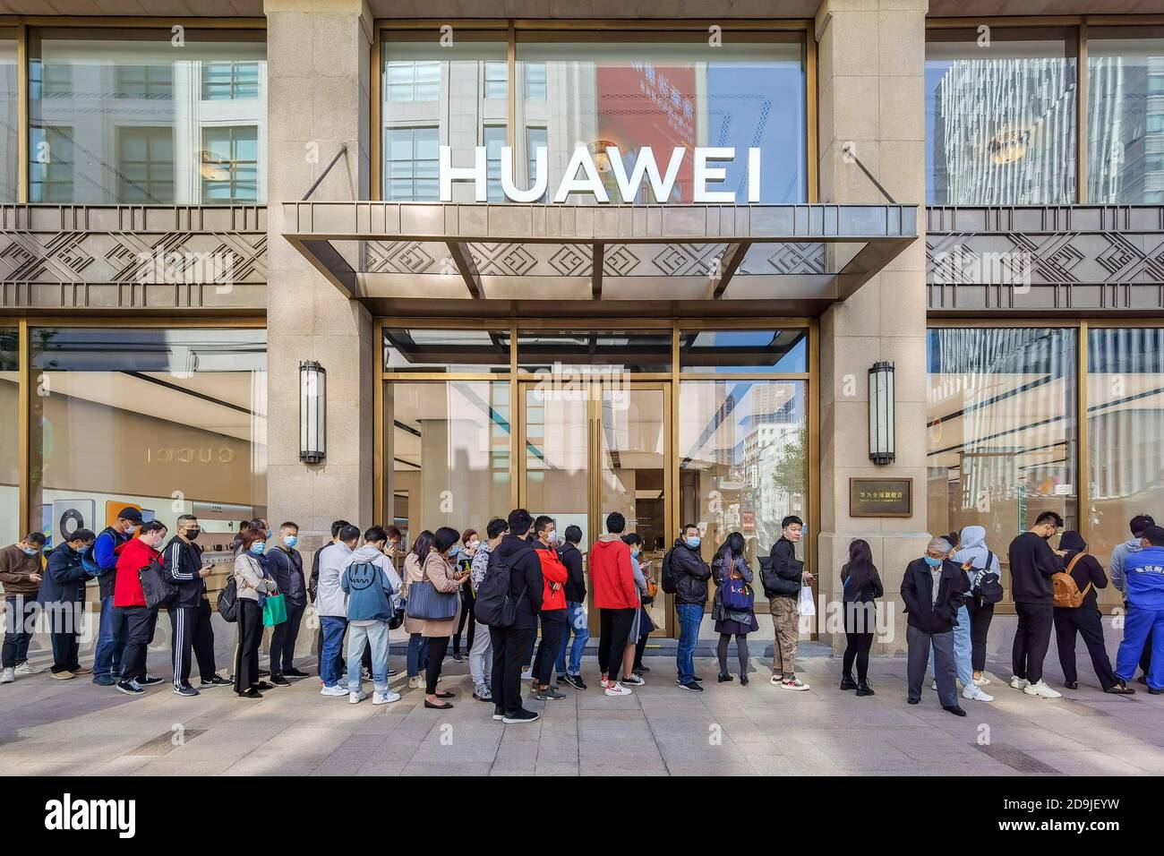 Customers queue at the flagship store of Huawei located on the east ...