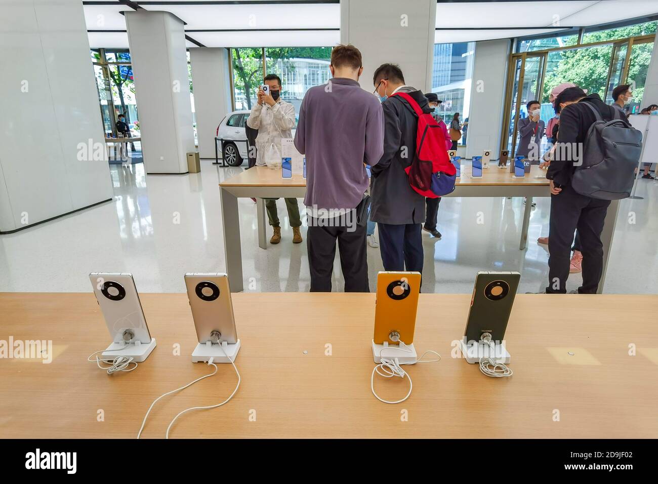Customers queue at the flagship store of Huawei located on the east ...