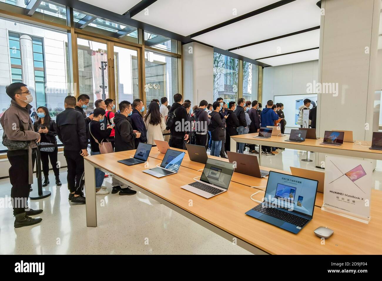 Customers queue at the flagship store of Huawei located on the east ...
