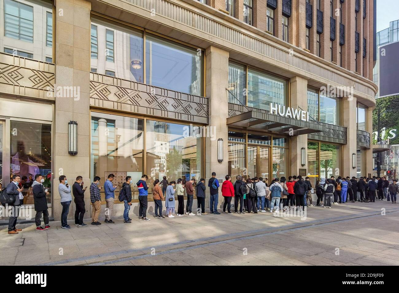 Customers queue at the flagship store of Huawei located on the east ...