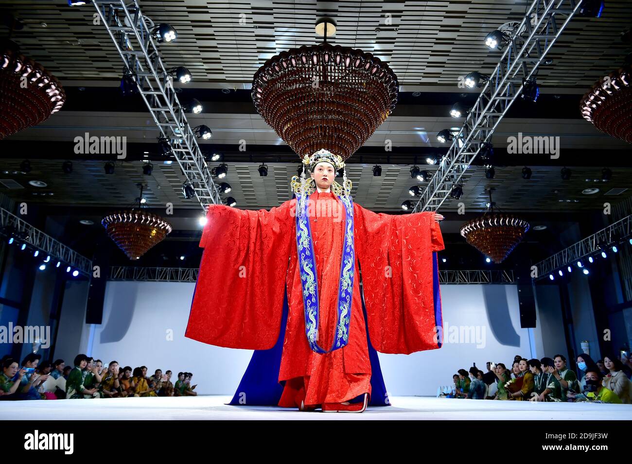 A model dresses in traditional Chinese clothes, walking on a T runway ...