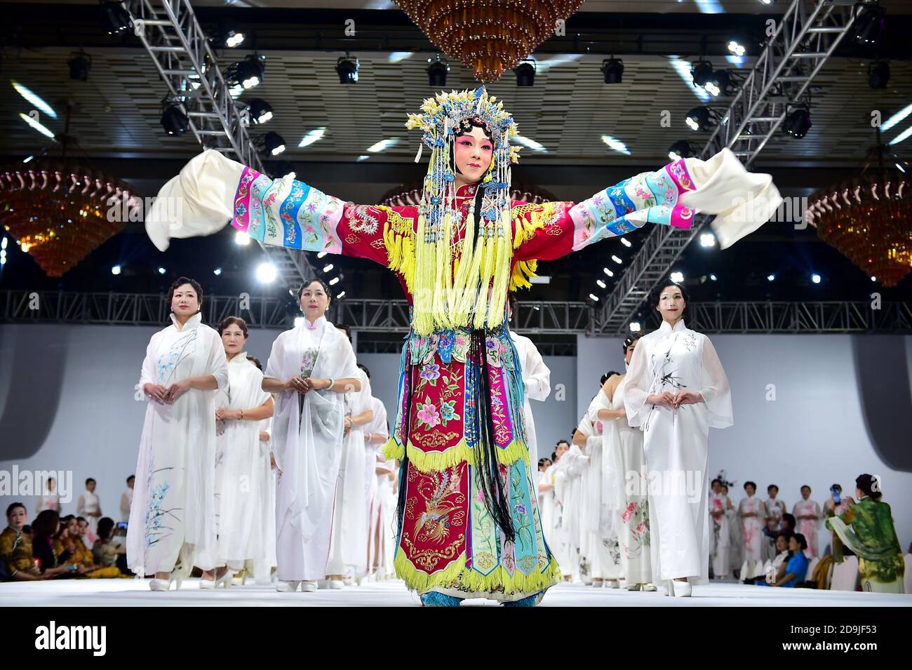 A model dresses in traditional Chinese clothes, walking on a T runway ...