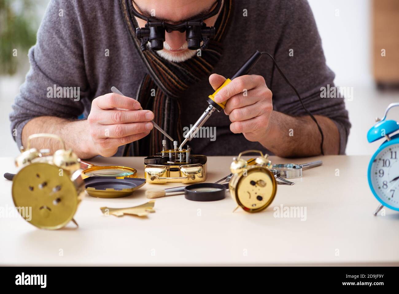 Old watchmaker working in the workshop Stock Photo - Alamy