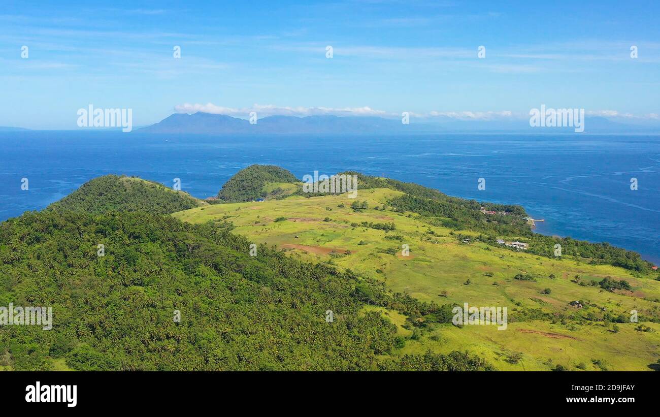 Seascape on tropical island with with blue sea. Slopes of mountains ...