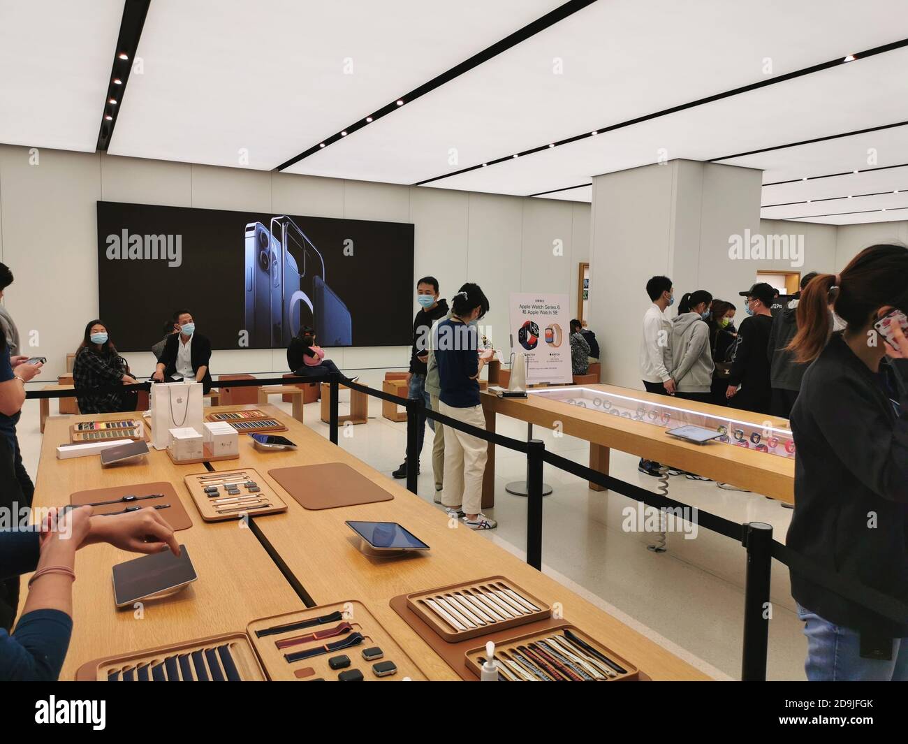 Customers flock to a flagship store of Apple to experience the new ...