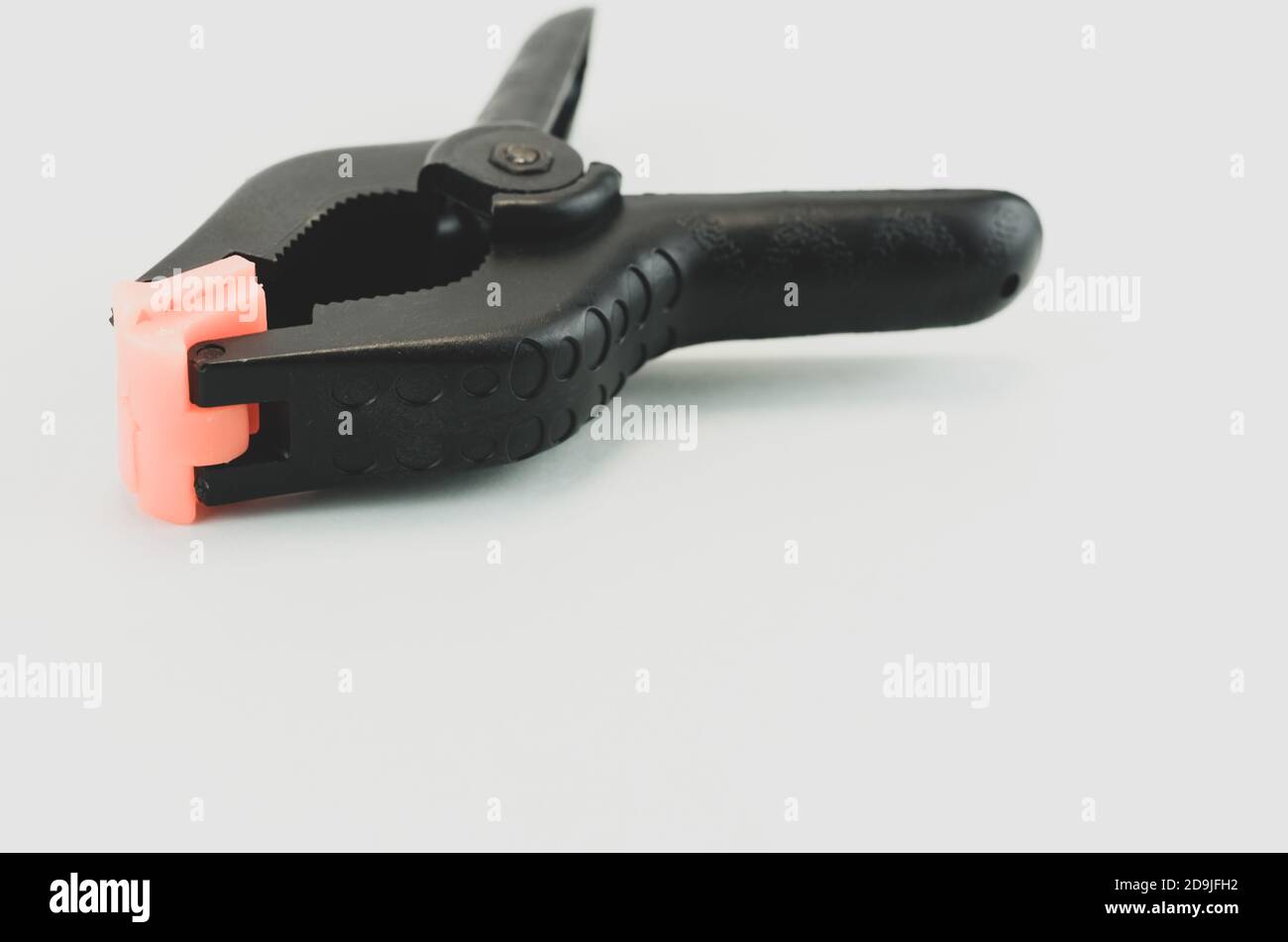 High angle shot of black plastic spring clamp with copy space isolated ...