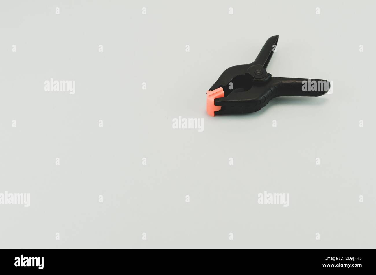 High angle shot of black plastic spring clamp with copy space isolated ...