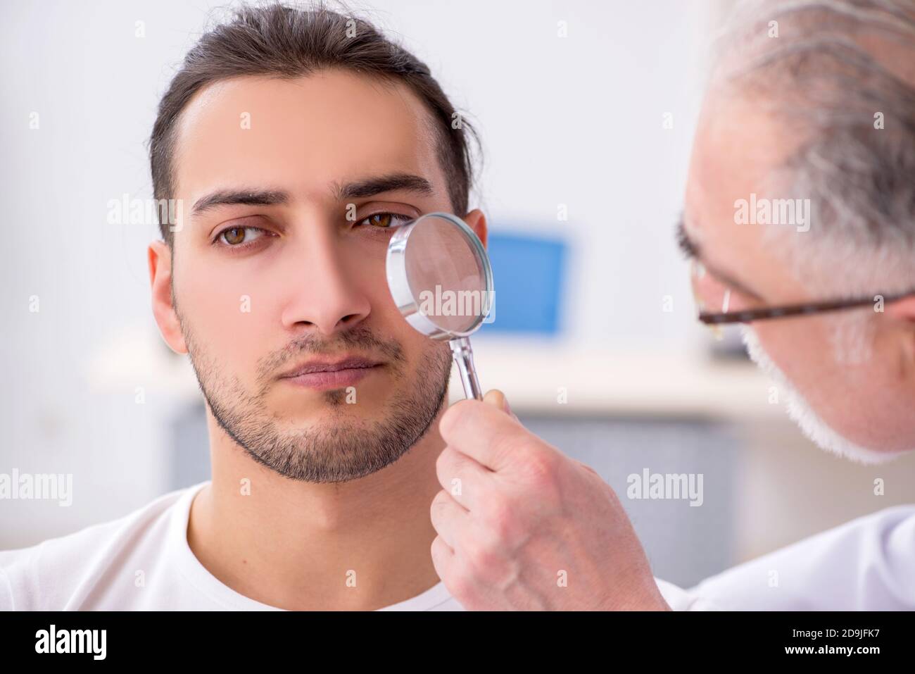 Young man visiting old doctor dermatologist Stock Photo - Alamy