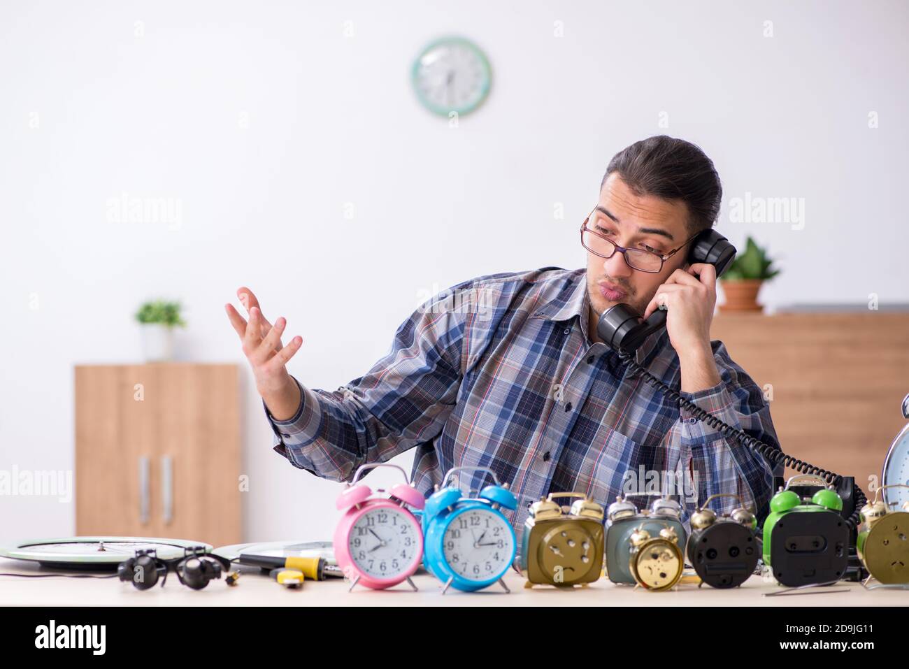Young watchmaker working in the workshop Stock Photo - Alamy