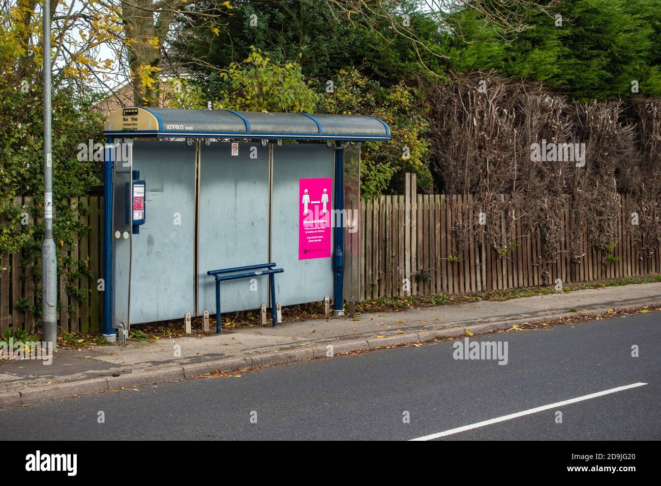 empty bus stop with seat and post box Stock Photo - Alamy