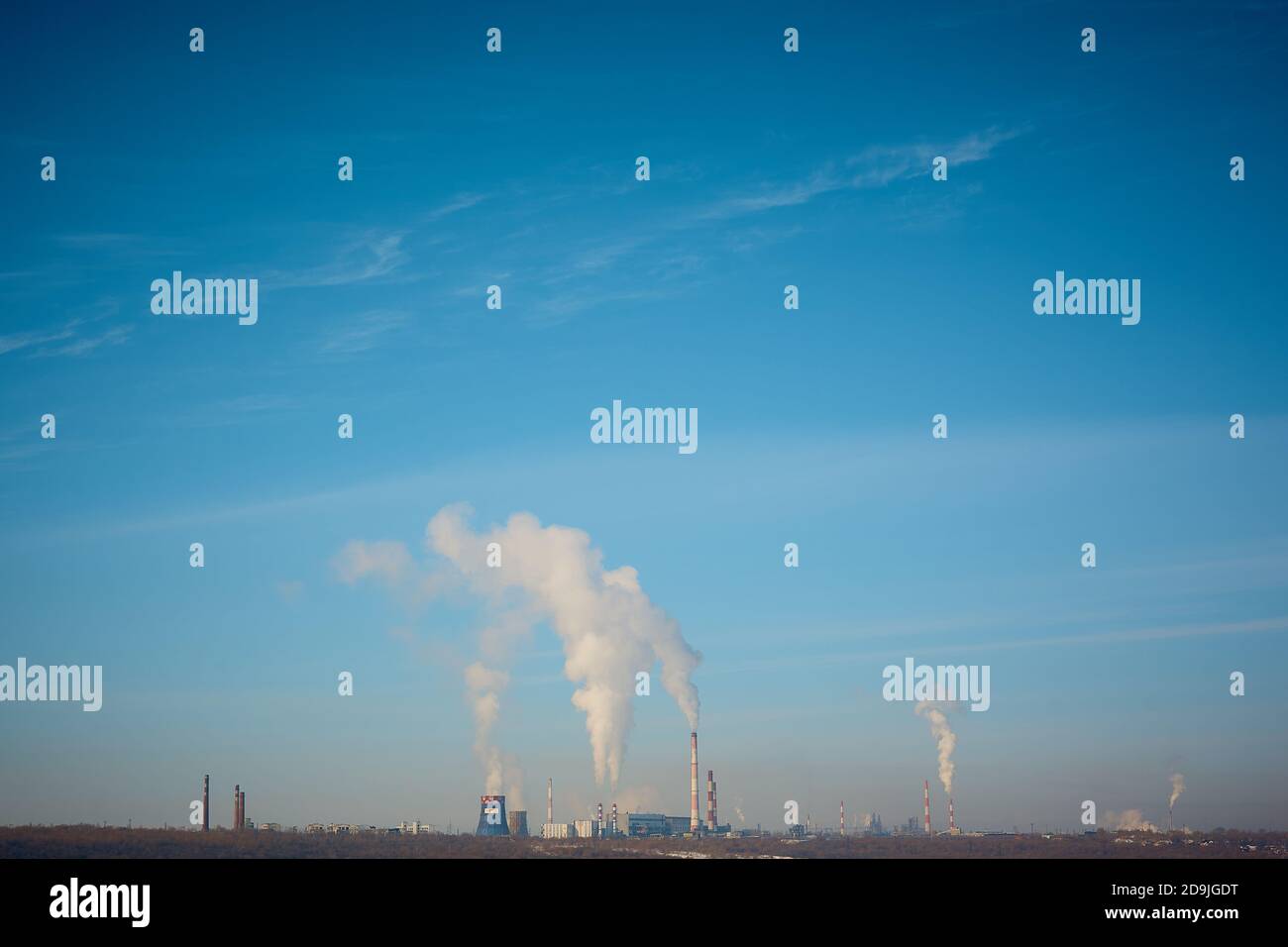 smoke from a pipe plant against a blue sky. Pollution of the ...