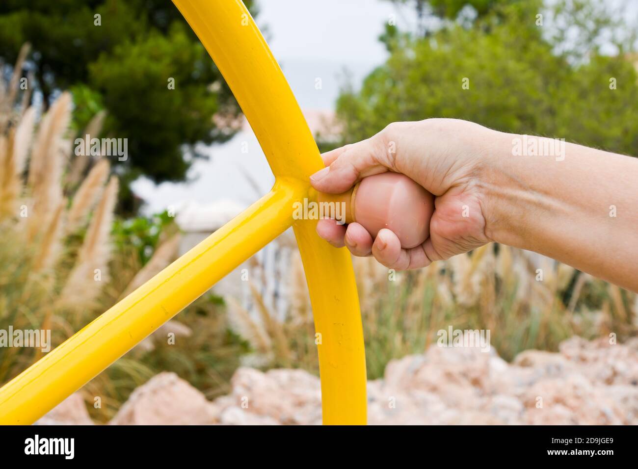 Closeup shot of a hand grabbing park exercise equipment Stock Photo - Alamy