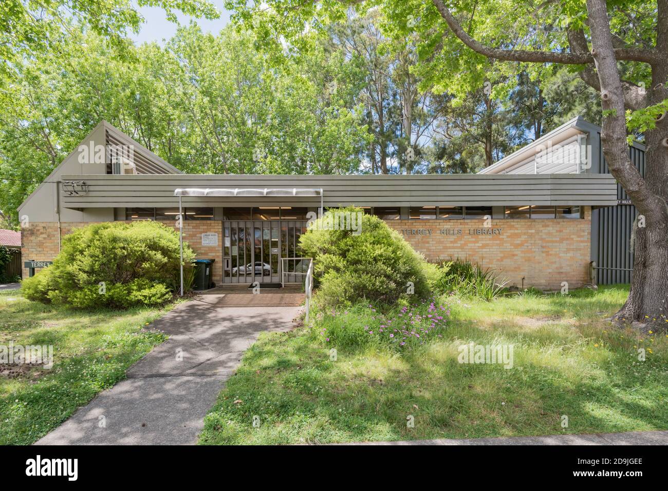 A blonde brick and unusual steel roof public lending library in the ...