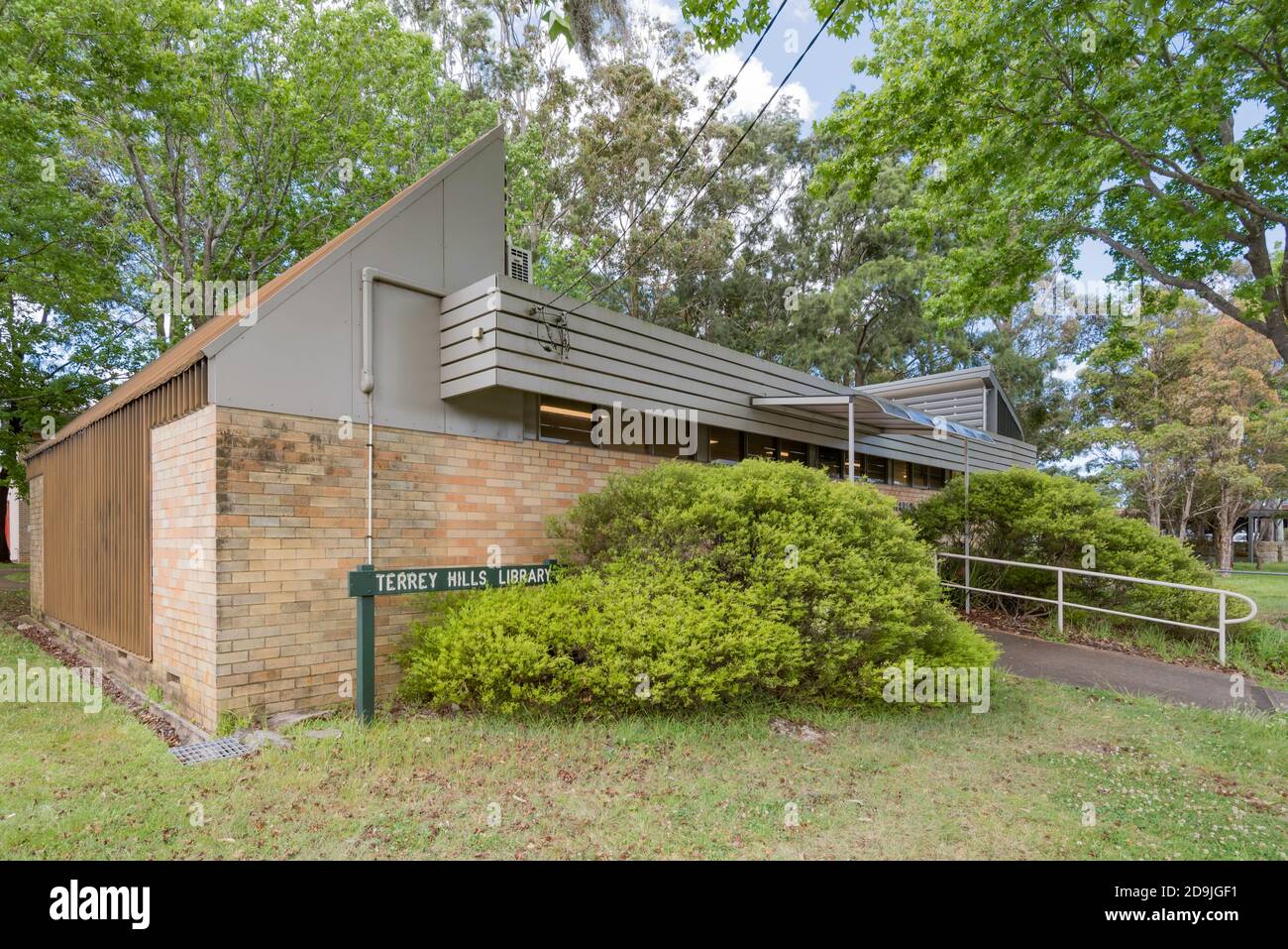 A blonde brick and unusual steel roof public lending library in the ...