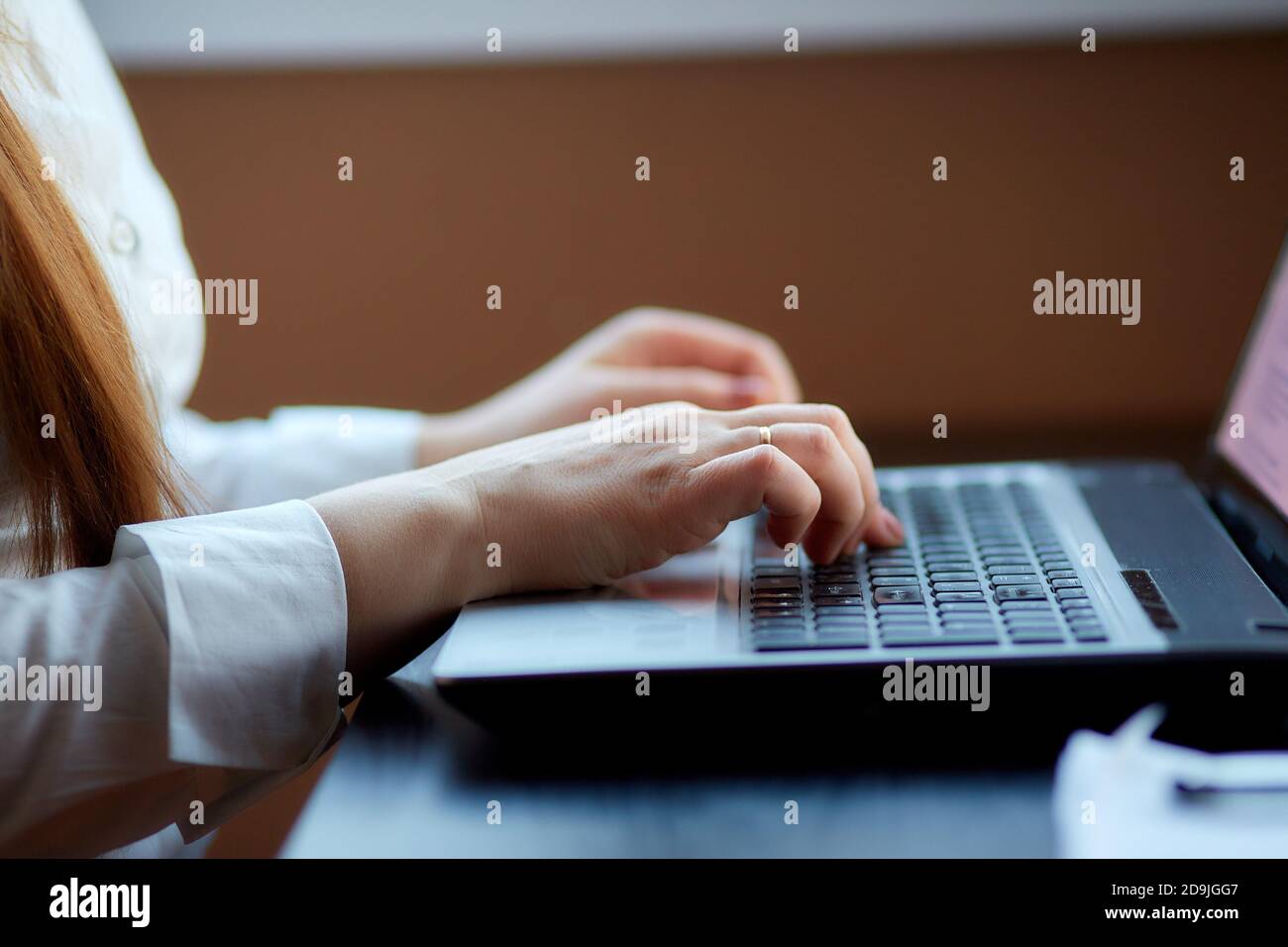 women's hands type a laptop on the keyboard, close-up. Workplace Stock ...