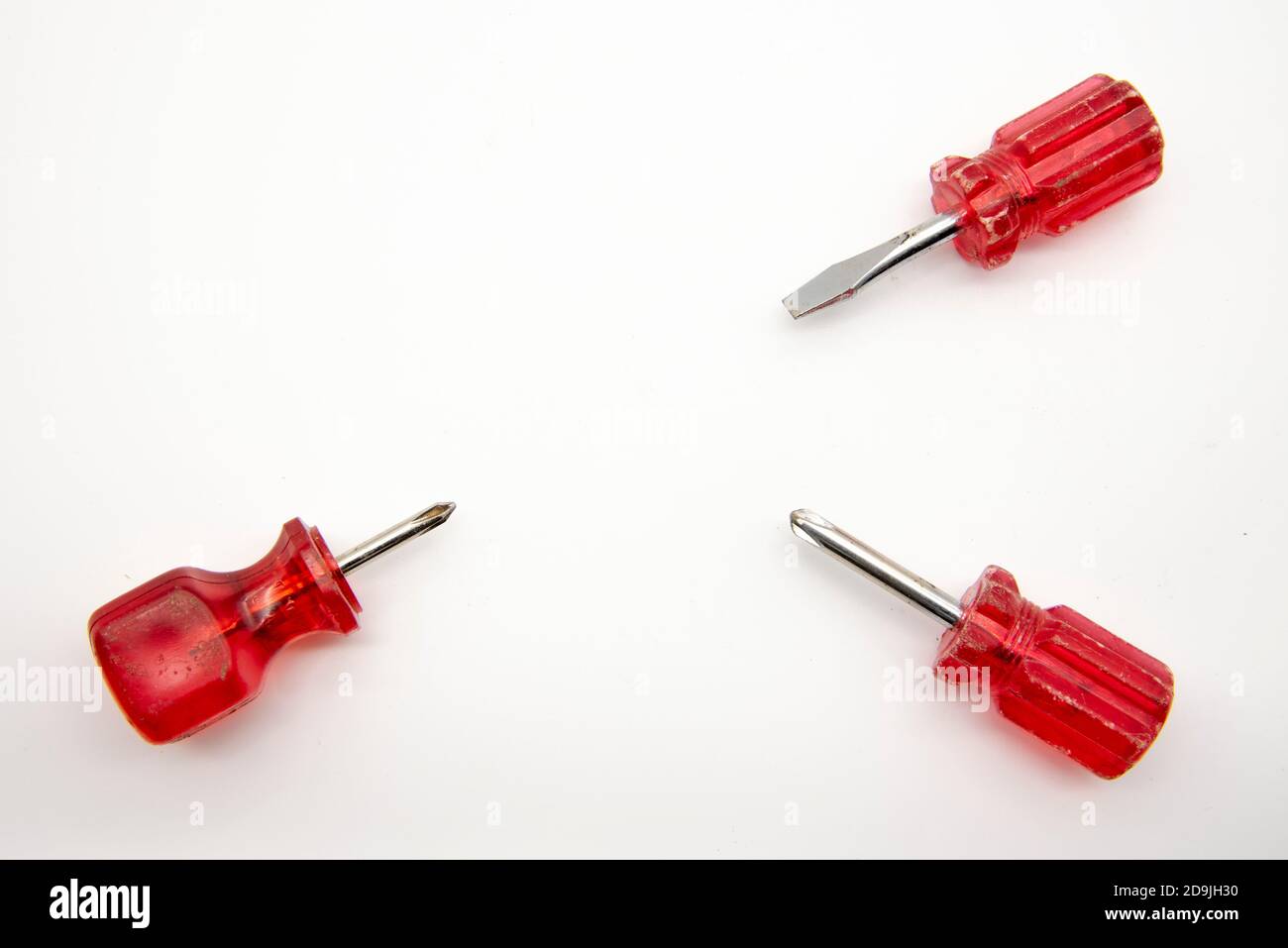 Three small screwdrivers with red handles on a white background Stock ...