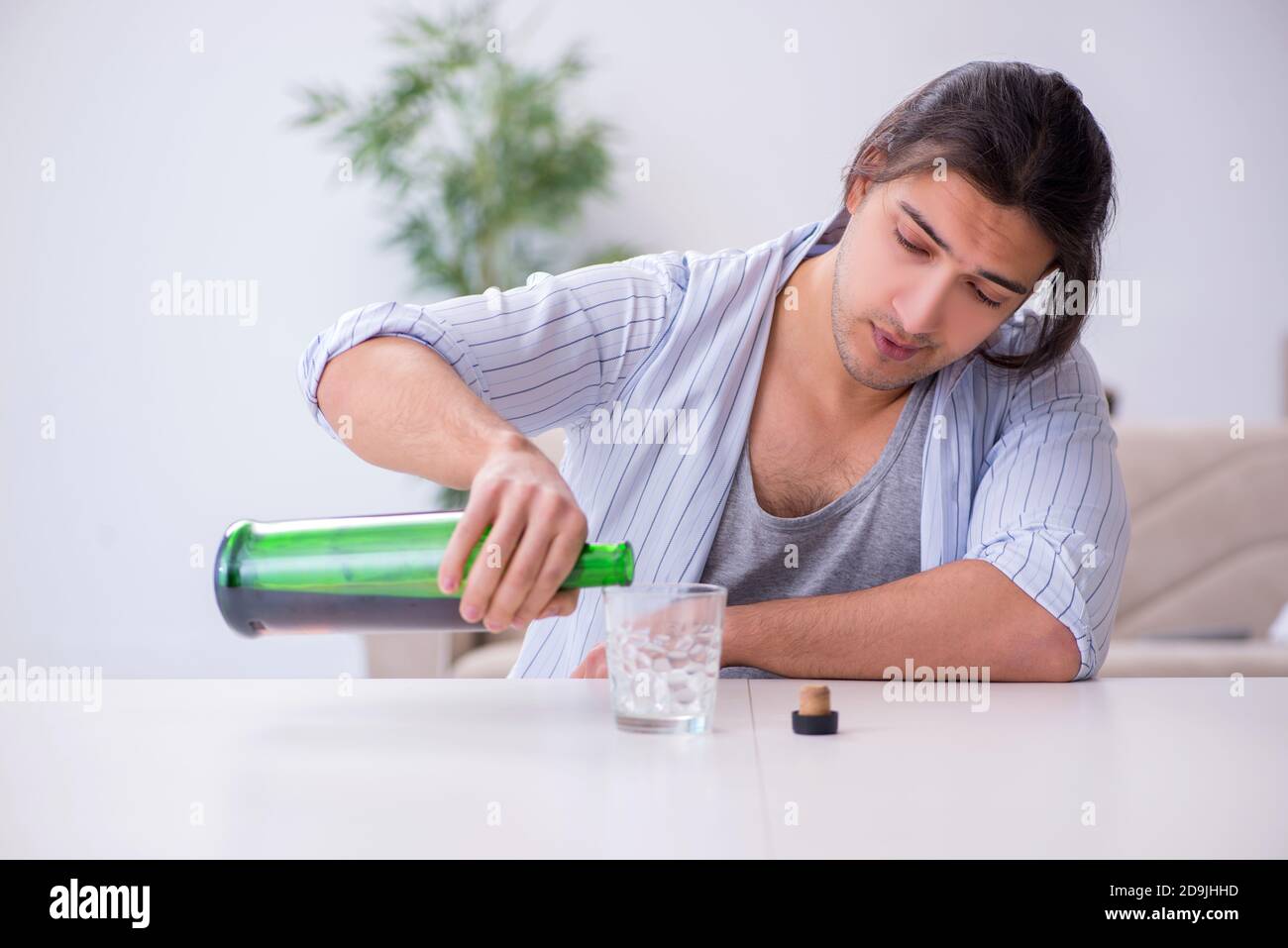 Male alcoholic drinking whiskey at home Stock Photo - Alamy