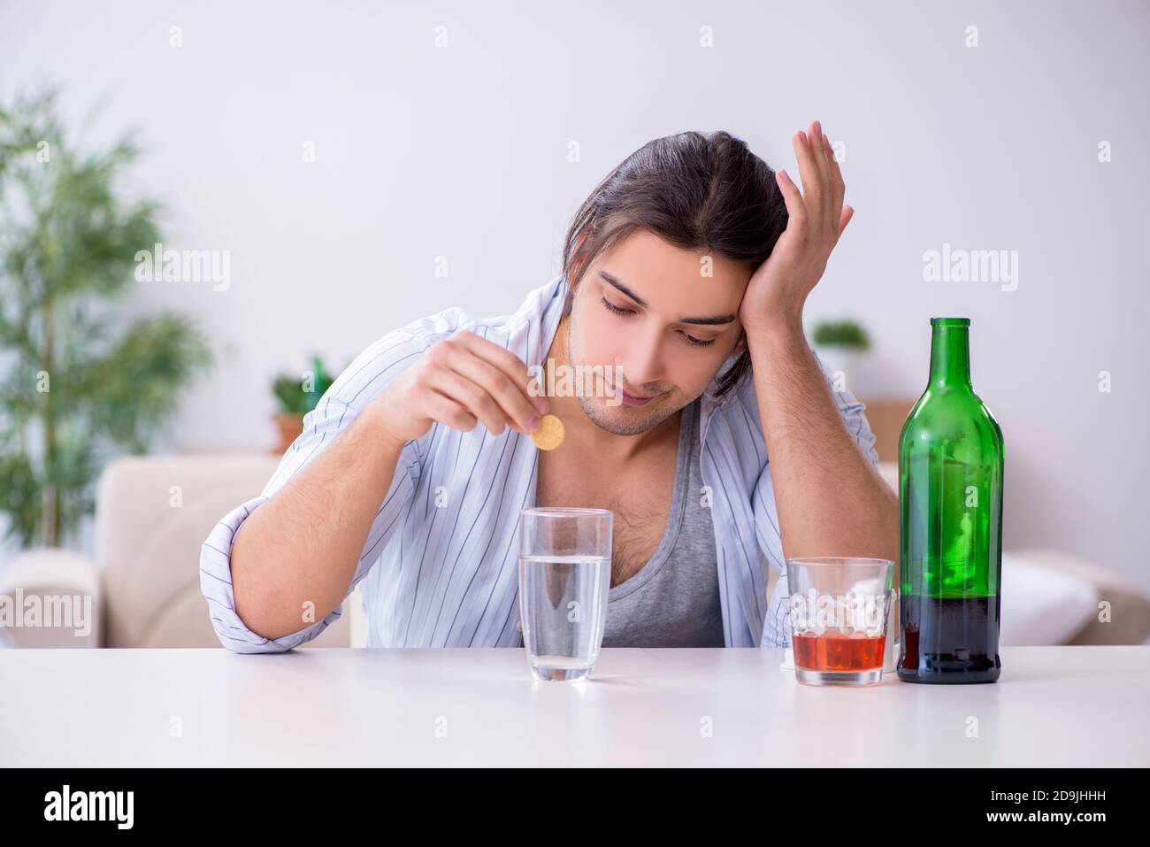 Male alcoholic drinking whiskey at home Stock Photo - Alamy