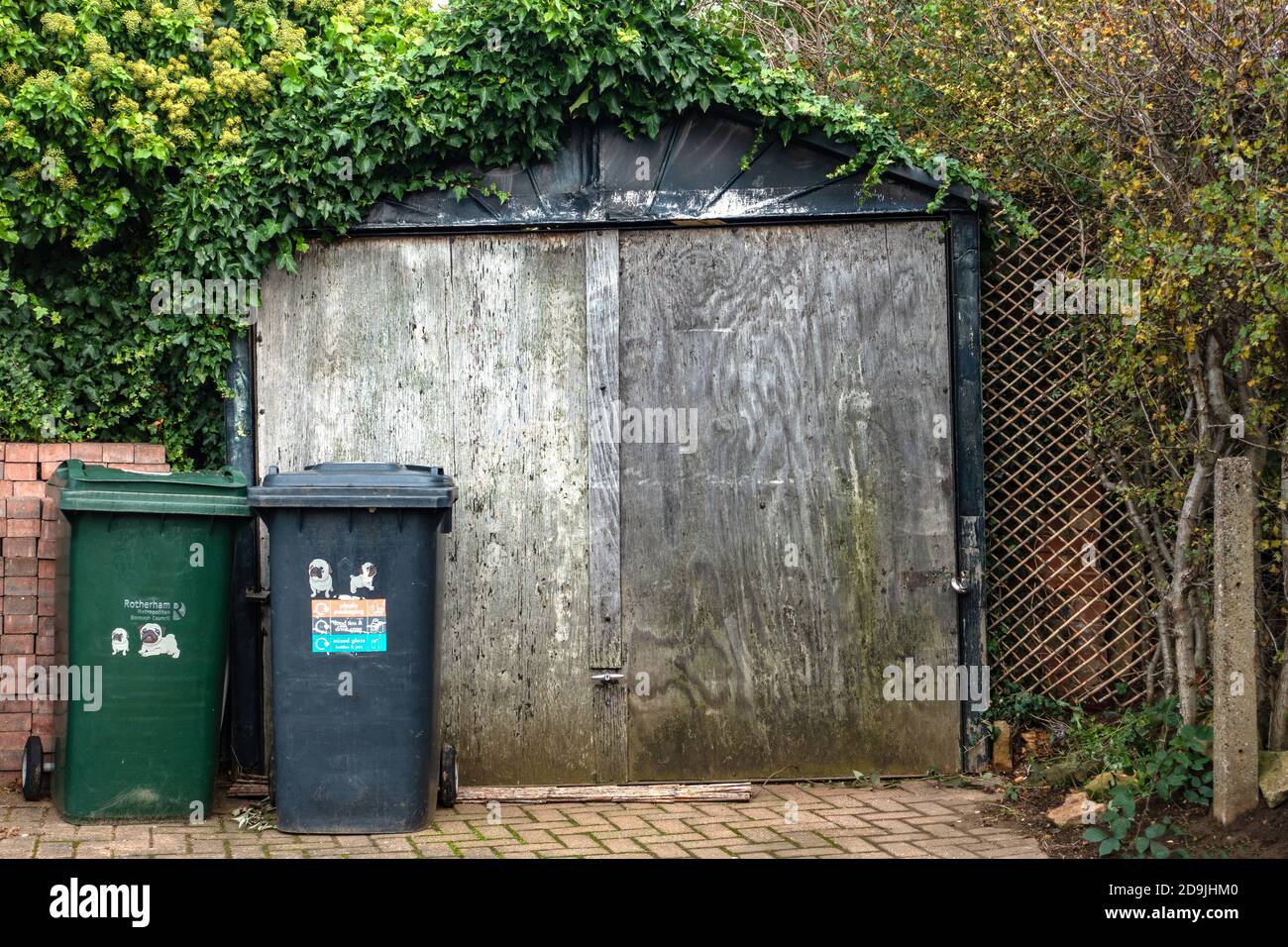 very old, home made overgrown car garage outside a home in sheffield ...