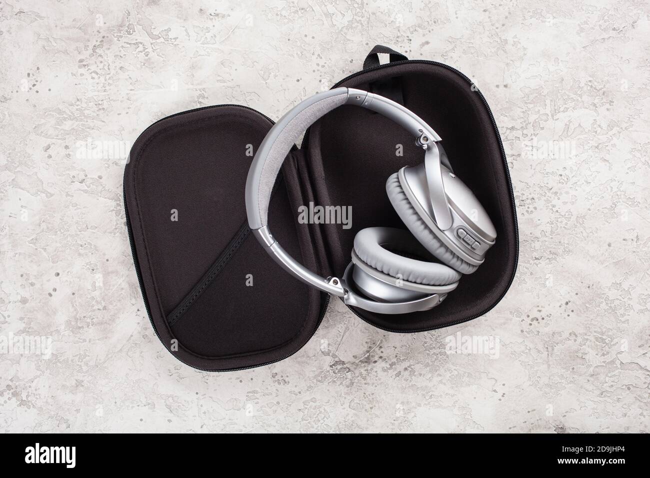 modern silver wireless headphones on concrete background Stock Photo ...
