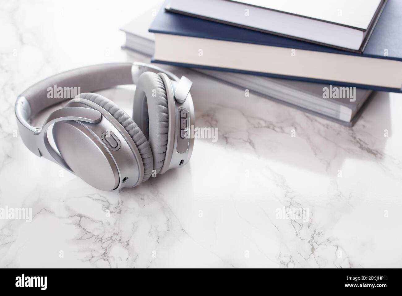 audiobook concept modern wireless headphones and book Stock Photo - Alamy