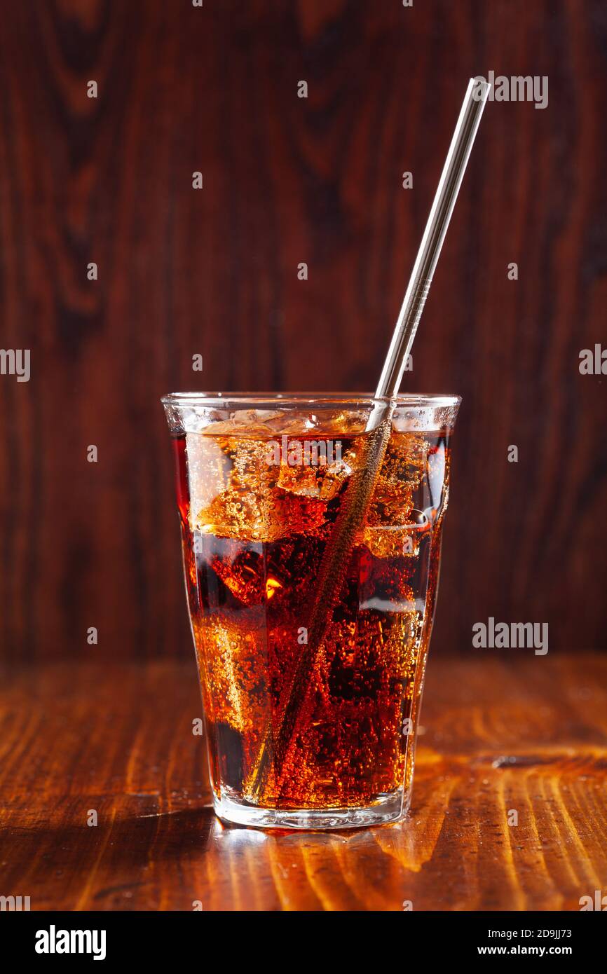 glass of cold cola soft drink with ice on wooden background Stock Photo ...
