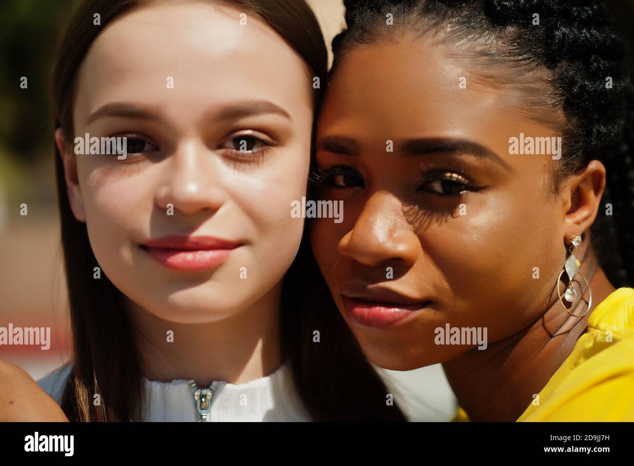 Close up faces of white caucasian girl and black African American ...