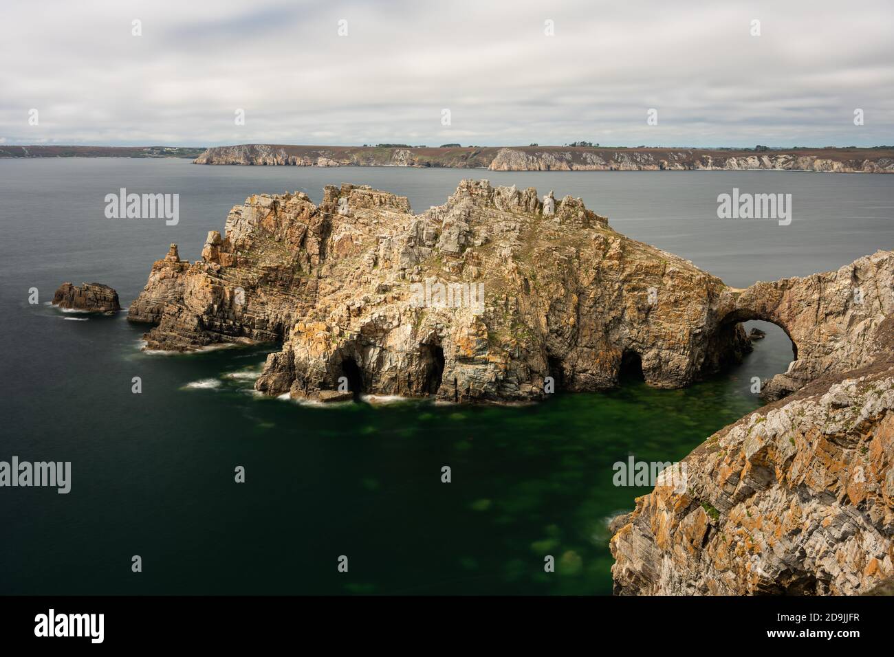 Sea arch at Pointe de Dinan (Crozon, Brittany, France) on a cloudy day ...