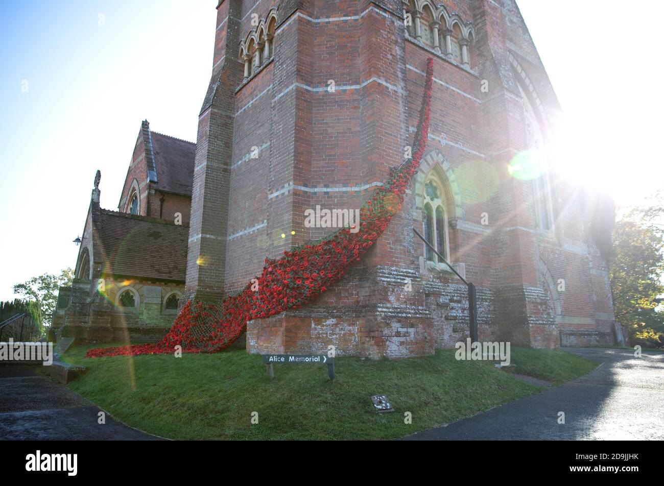 Hand knitted poppies creating 'A Fall of Poppies for the Fallen' hang ...