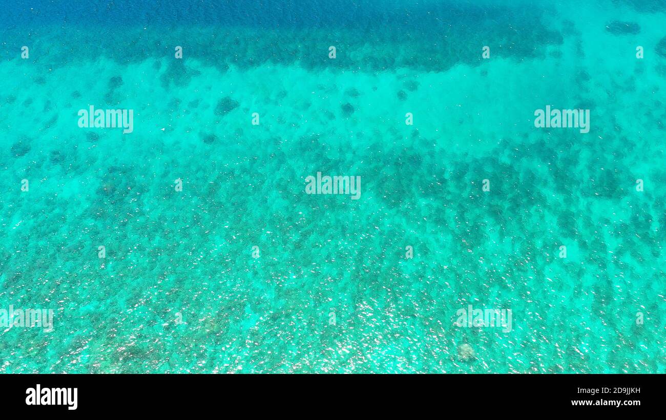 Turquoise lagoon surface on atoll and coral reef, copy space for text ...