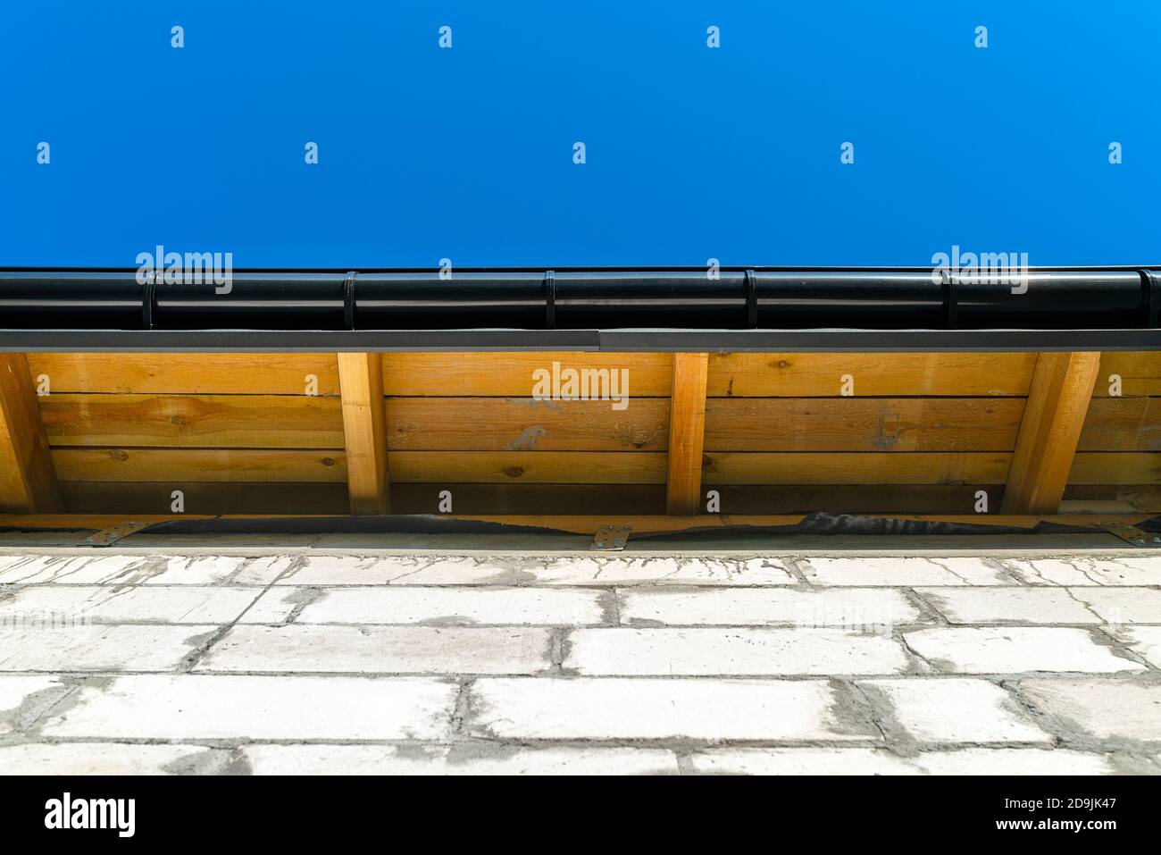 Construction of a small house made of white brick, visible gable roof ...
