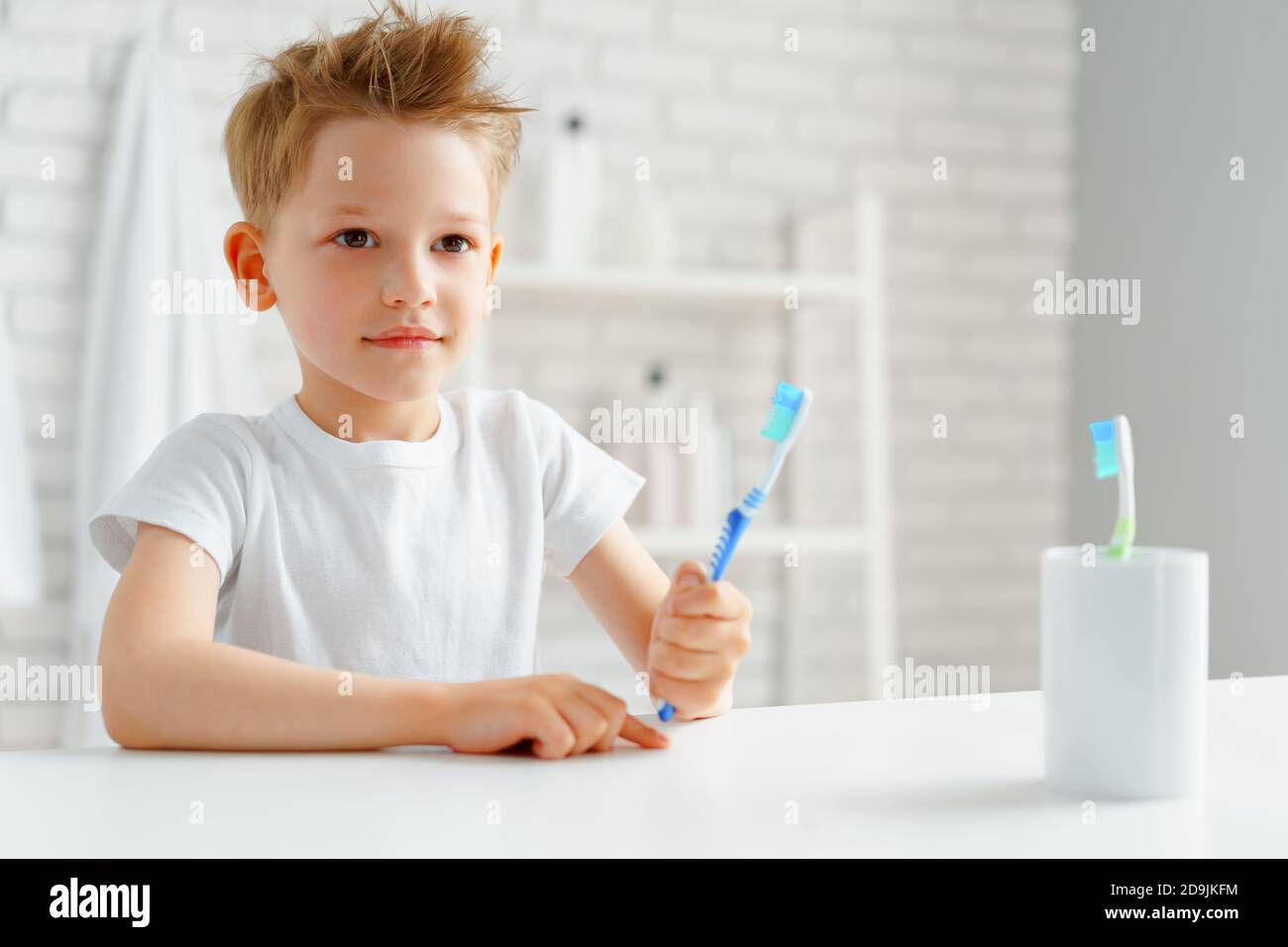 Little boy holding toothbrush in his hand Stock Photo - Alamy