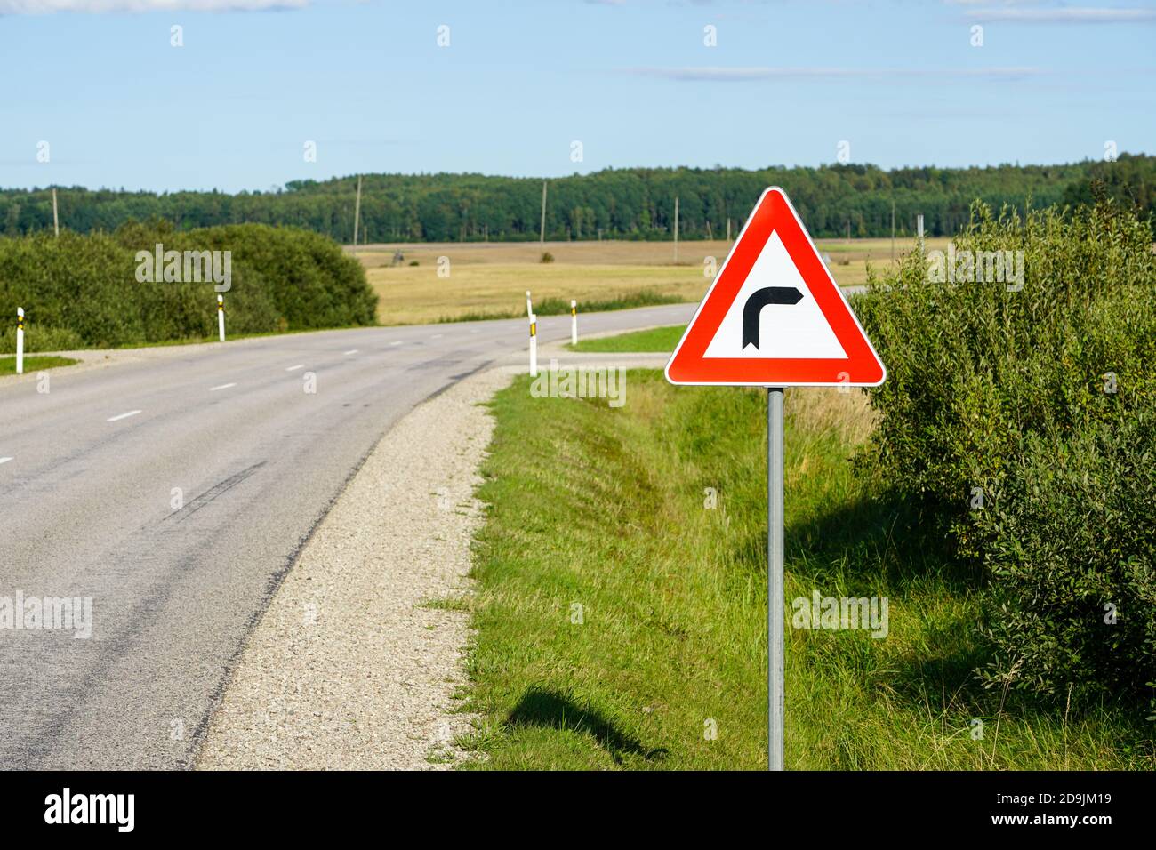 warning road sign turn right on the background of an asphalt road and ...