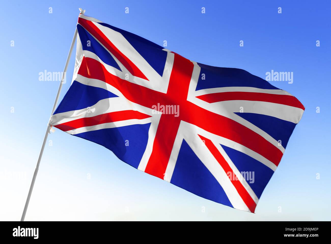 Flag of Great Britain waving against blue sky Stock Photo - Alamy