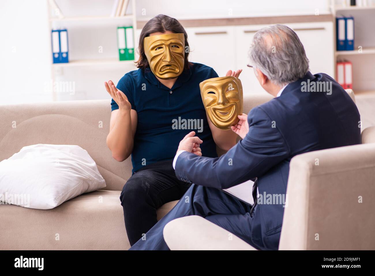 Man wearing masks during psychotherapy session Stock Photo - Alamy