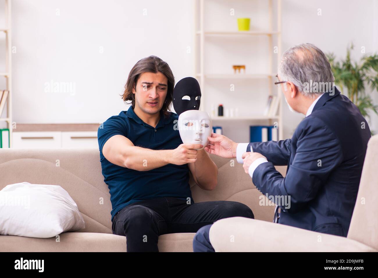 Man wearing masks during psychotherapy session Stock Photo - Alamy