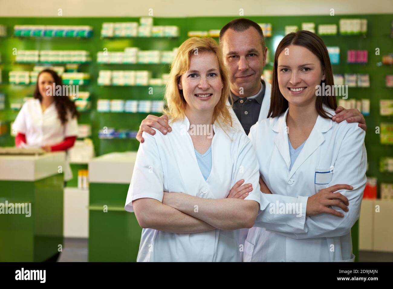 Pharmacist with his pharmaceutical-technical assistants in pharmacy ...