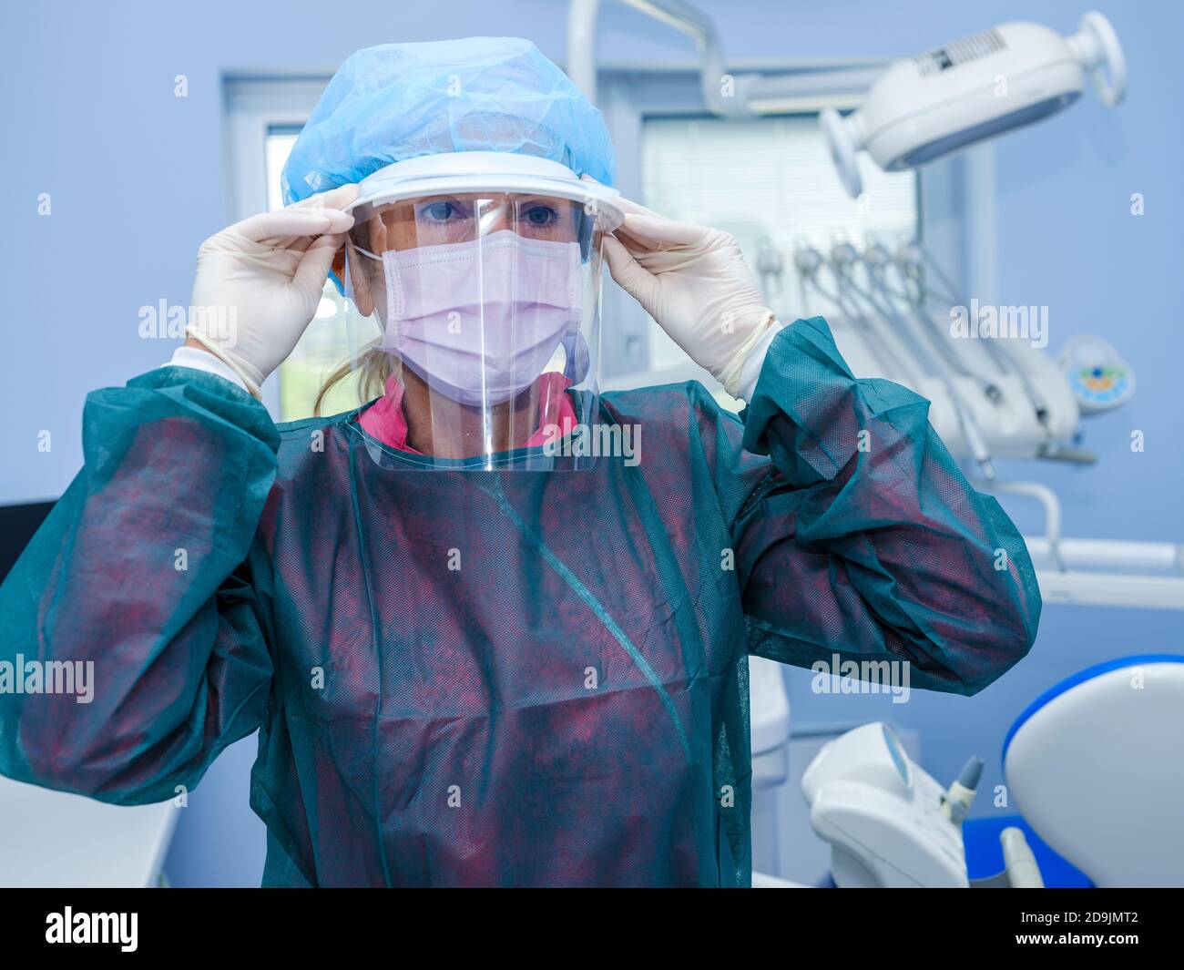 Doctor wearing a plexiglass face mask to protect herself from the covid ...