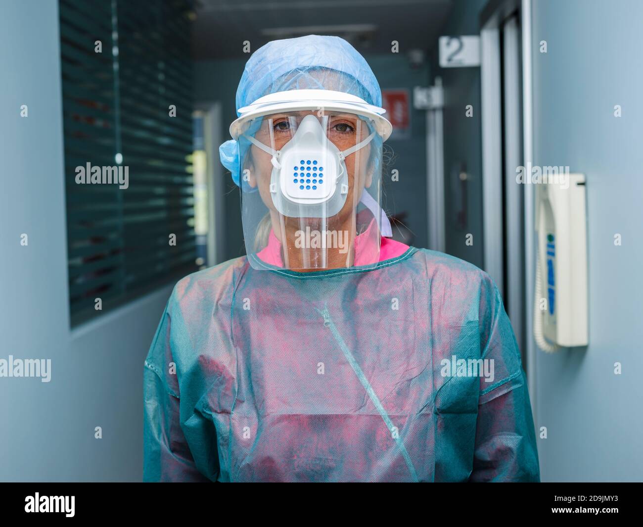 Doctor wearing a plexiglass face mask to protect herself from the covid ...