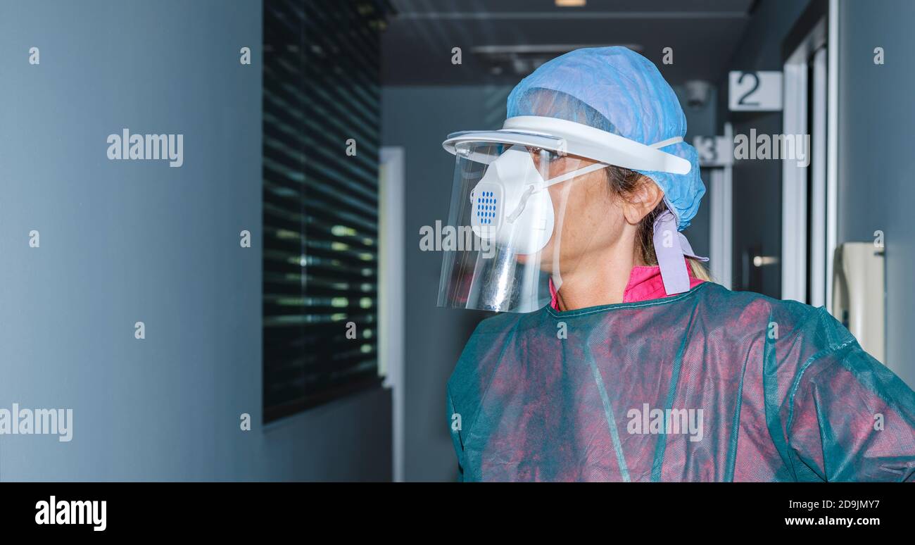 Doctor wearing a plexiglass face mask to protect herself from the covid ...