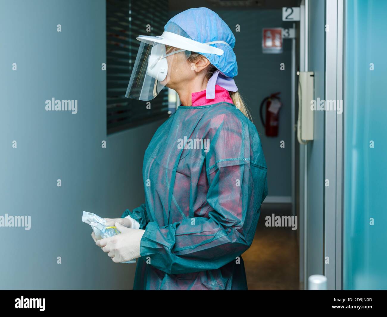 Doctor wearing a plexiglass face mask to protect herself from the covid ...