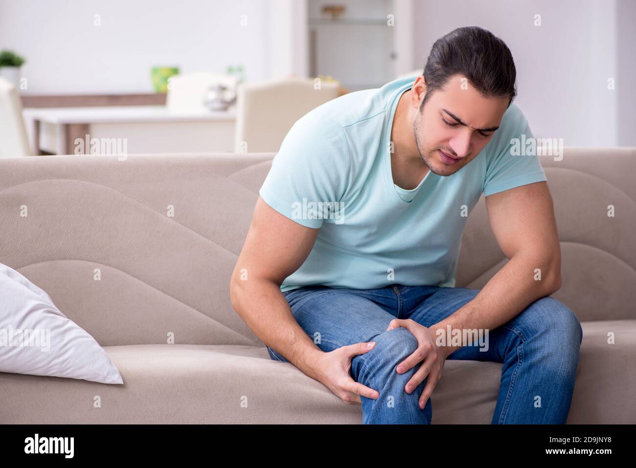 Injured young man suffering at the home Stock Photo - Alamy