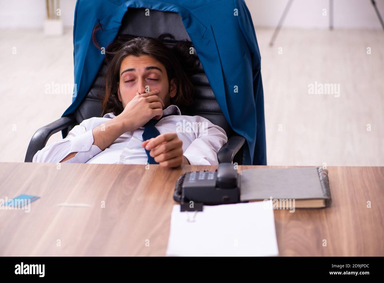 Drug addicted employee working in the office Stock Photo - Alamy