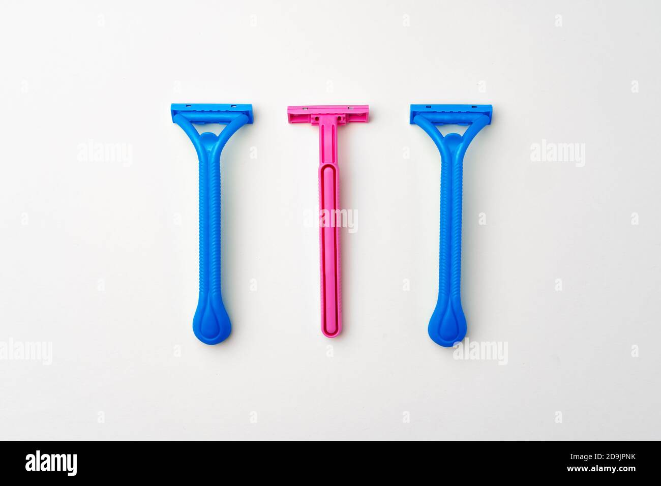 Pink and blue razors on white background Stock Photo - Alamy