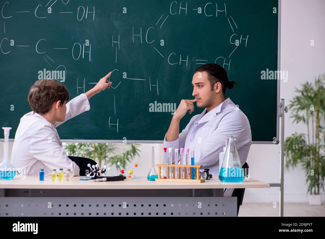 Young chemistry teacher and schoolboy in classroom Stock Photo - Alamy