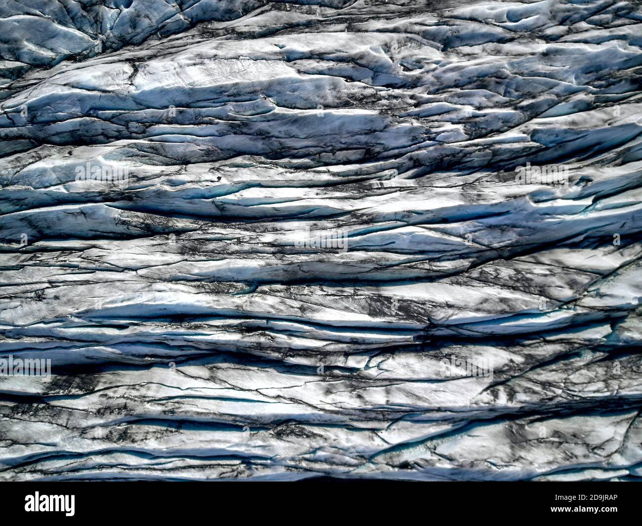 Aerial view of glacier from above, ice and ashes of the volcano texture ...