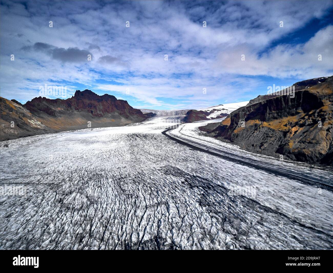 Aerial view of glacier from above, ice and ashes of the volcano texture ...