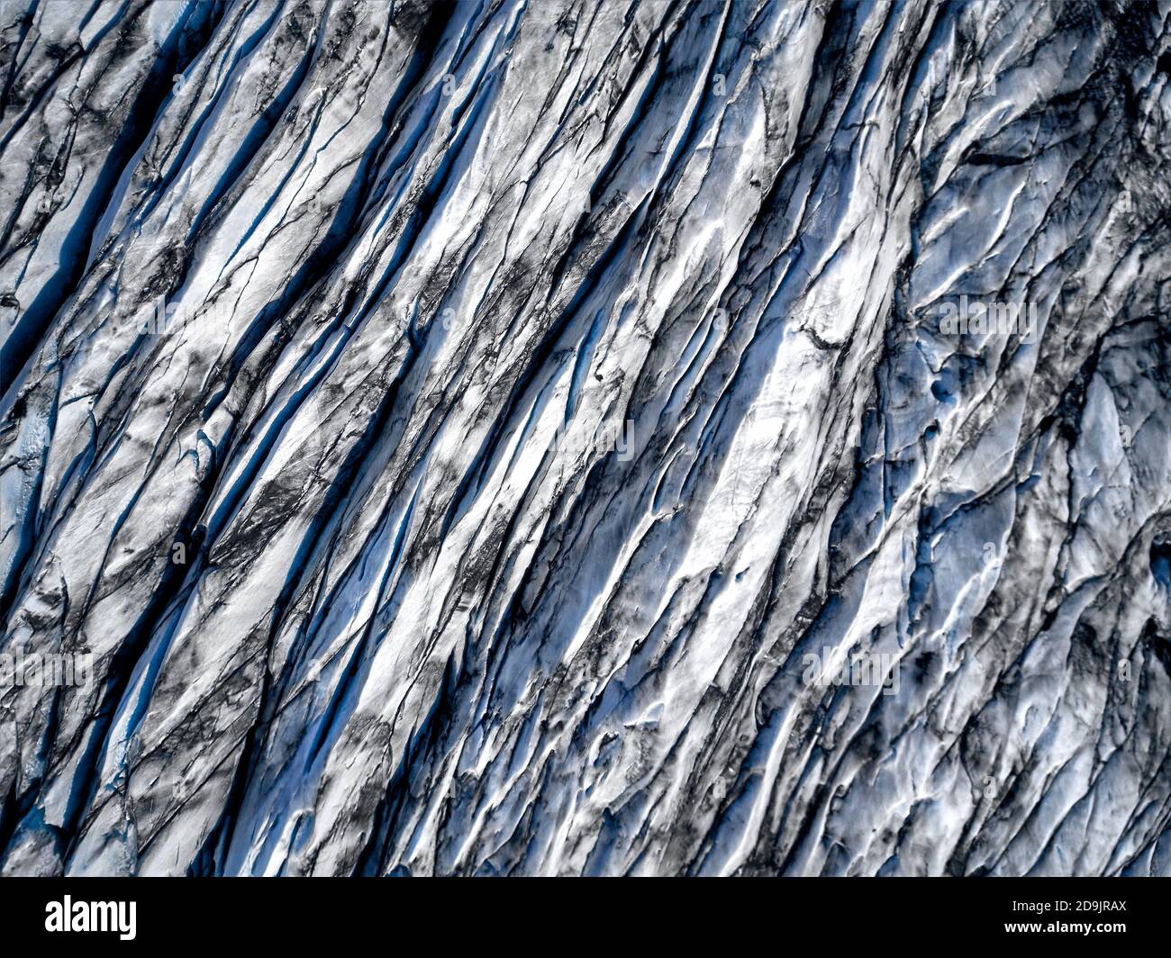 Aerial view of glacier from above, ice and ashes of the volcano texture ...